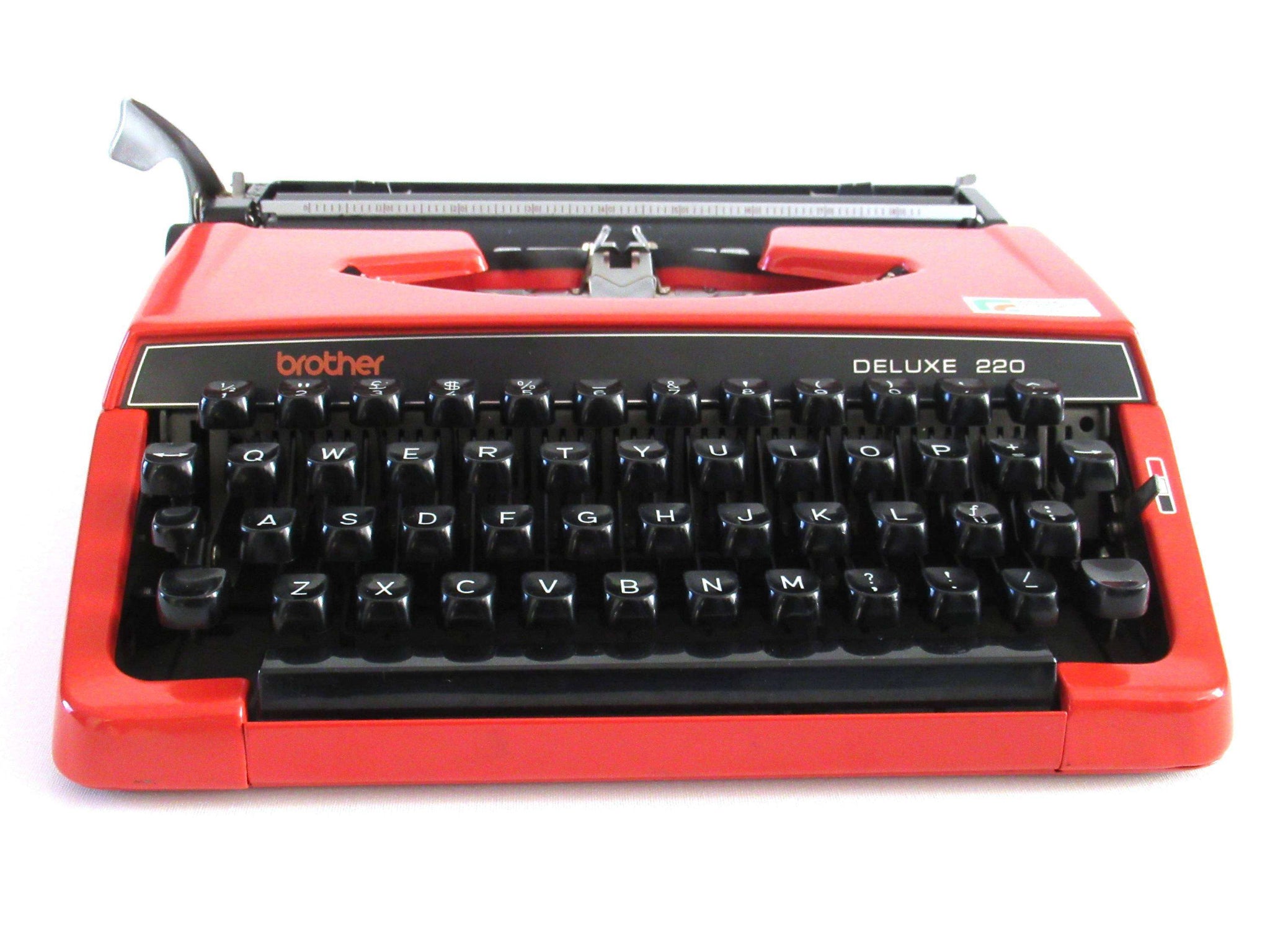 Brother Deluxe 220 working typewriter. Red metal body, two tone ink ri ...